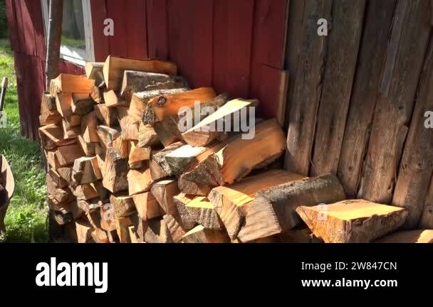 man hands with gloves stack wood firewood near woodshed house wall. 4K ...