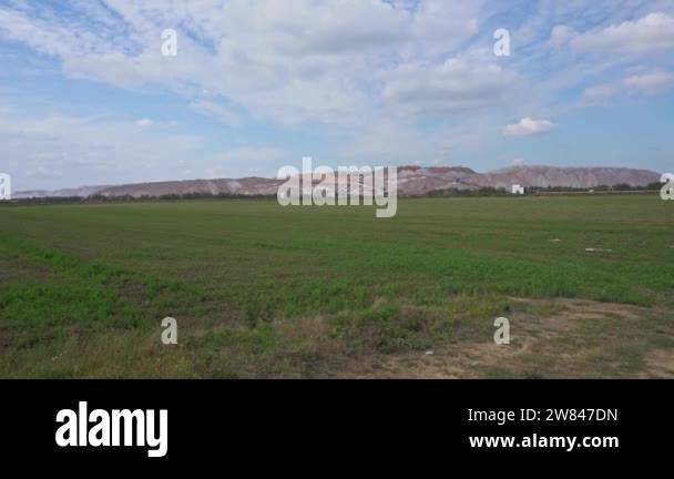 Mining industry. Mining dump trucks drive on potash heaps in a quarry ...