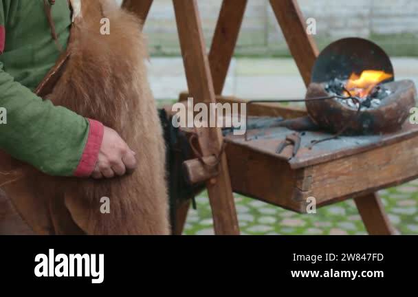 ancient forge and blacksmith sinks the bugle in the manual medieval ...