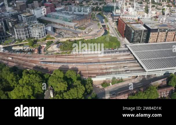 High angle view of long passenger train driving through city. Modern ...