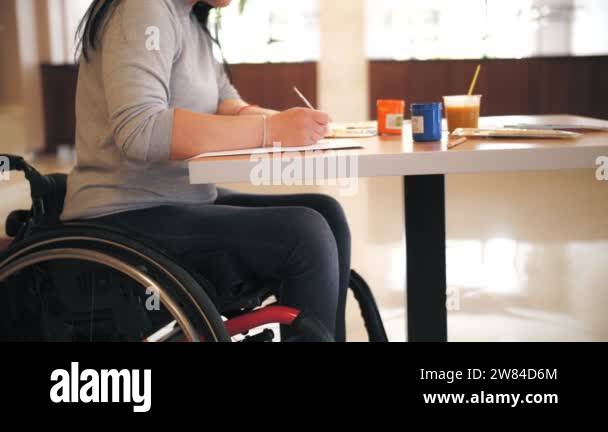 wheelchair. disability. close-up. disabled young woman draws paints, sitting in wheelchair at ...
