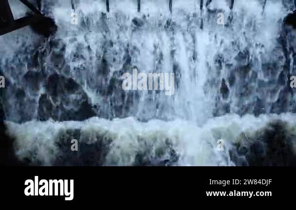 Water flowing out of a large dam. Overflow dam. Deshcharge water in dam ...