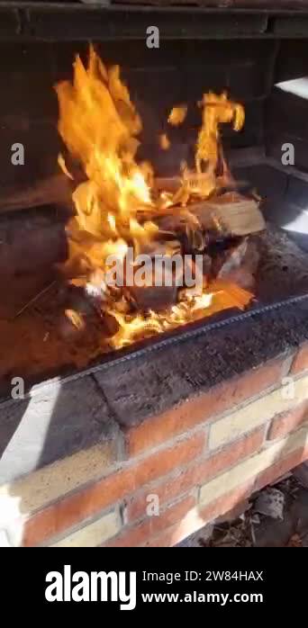 A traditional oven with a burning fire inside for cooking. Inside, raw ...