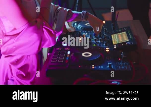 DJ hands control sound console for mixing music in disco club. Close up ...