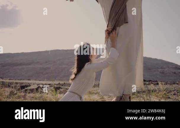 Mary falls at Jesus feet and mourns his death. Wind is blowing Stock Video Footage - Alamy