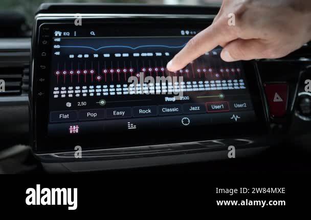 Man finger changing car audio equalizer settings using smart multimedia ...