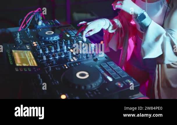 DJ hands control sound console for mixing music in disco club. Close up ...