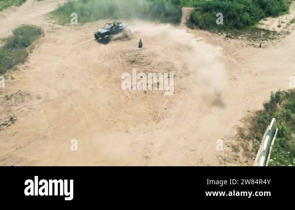 Dusty terrain with a racing car being driven fast through it. 4K Stock ...