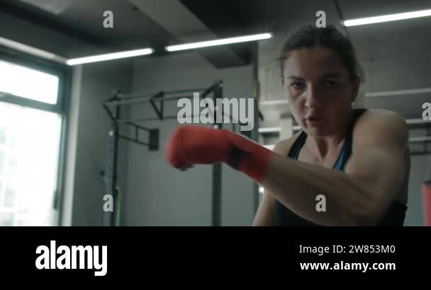 Mixed martial art fighter woman does shadow boxing to the camera in the ...