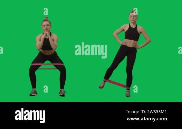 Young woman in sportswear does exercises with a fitness rubber band ...