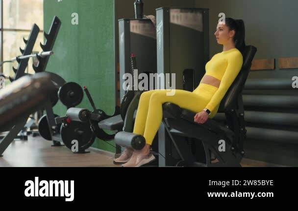 Strong hispanic brunette sportswoman doing legs exercise on sport ...