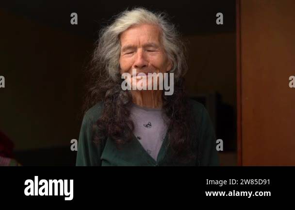 Wrinkled face of an old country woman. Elderly lady smiling while ...