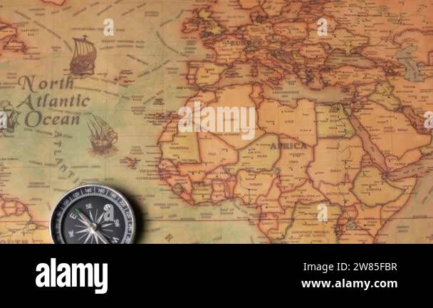 Compass lying on the ancient map. An old-fashioned instrument was used ...