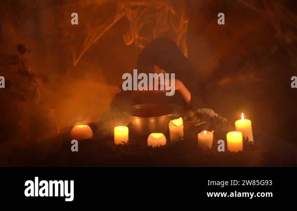 The underworld. Scary witch does voodoo black magic ritual near the ...