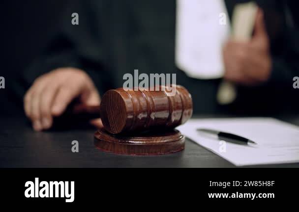 Judge hand hitting hammer three times, announcing end of proceeding in ...