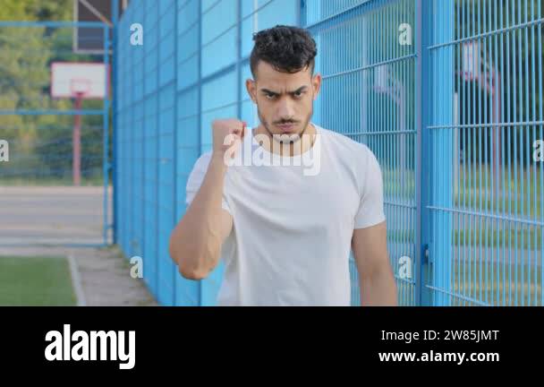 Angry excited football fan young Arabic Hispanic male athlete waving ...