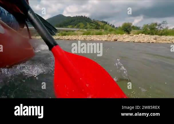 Rafting on a mountain river rafting. Athlete rowing with an oar close ...