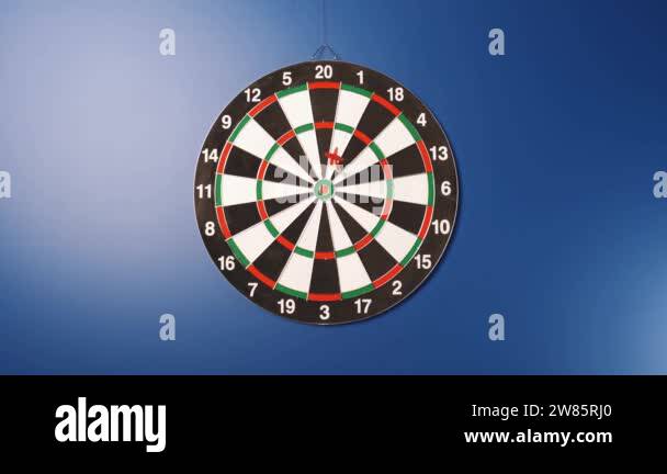 A game of darts. Throwing darts at the target. And someone will throw ...