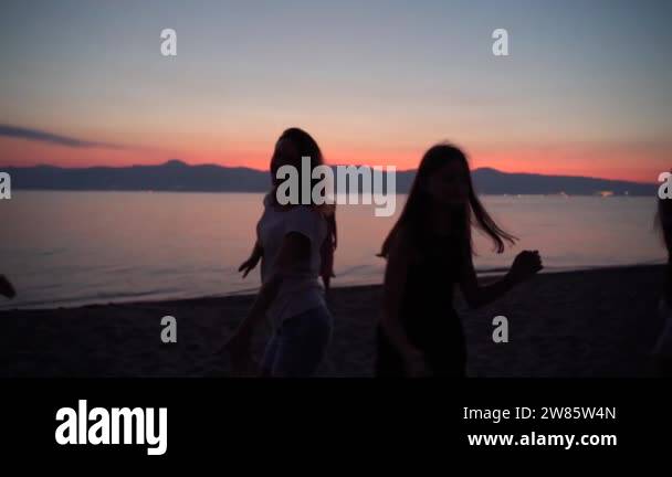 Joyful crowd of people celebrating party at the sea beach, moving ...