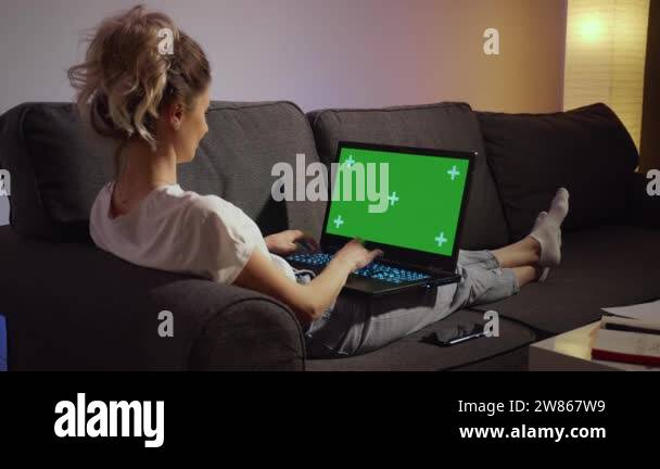 Over the shoulder shot of a woman working home looking at Green Screen ...