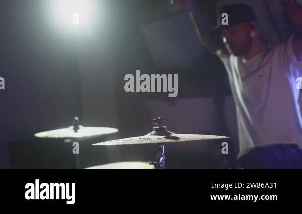The drummer hits the wet drum cymbal with his drumstick and the water ...