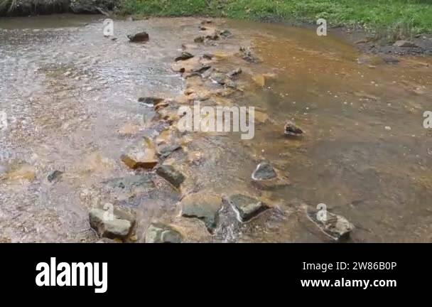 mountain river. the bottom of the rivers is made of clay. fast water ...
