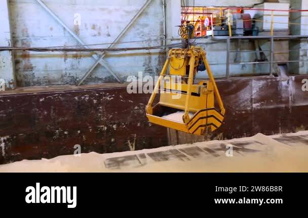 The girder crane loads fertilizer. A girder crane in a warehouse is ...