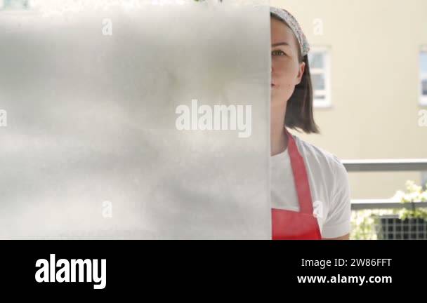 Cleaning service worker or housewife washes the windows using foam and ...