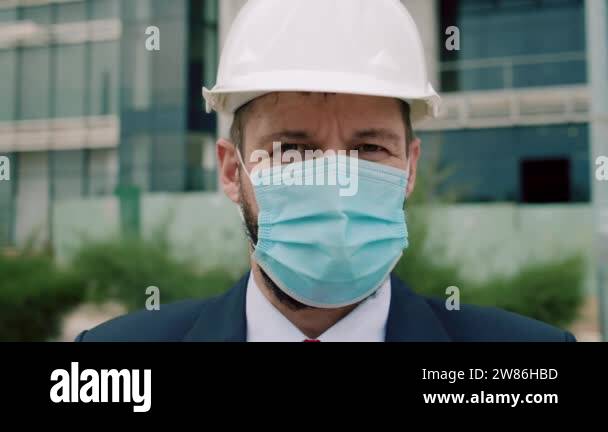 Close up portrait senior engineer wearing a white safety helmet with a ...