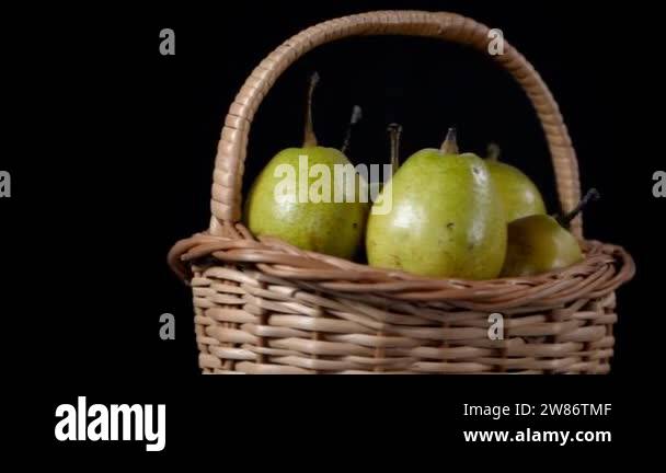 A heap of green and golden pears / Naak kept together in a bamboo ...