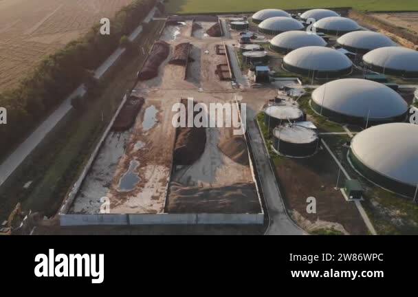 Organic biofuel plant on green field. Modern biogas plant among nature ...