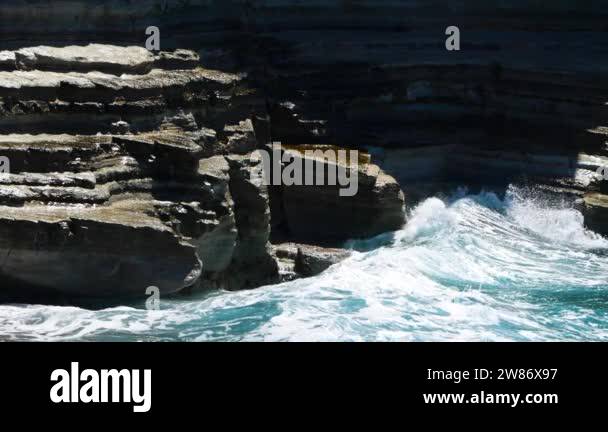 Waves breaking over dangerous rocks, Sea storm concept, Sunny daytime ...