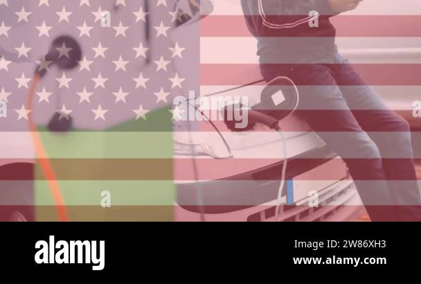 Flag of united states of america over man charging electric car. ev ...