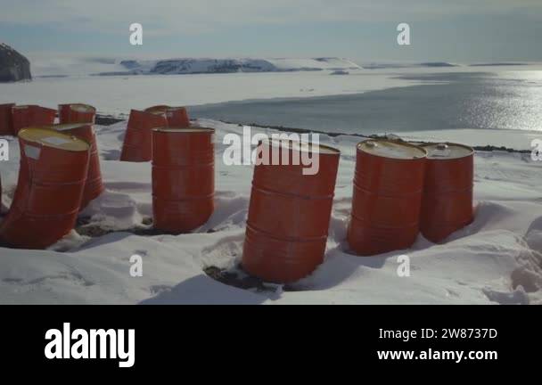 Barrels on snow-covered shore. Garbage. Barrels on snow. Fuel in ...