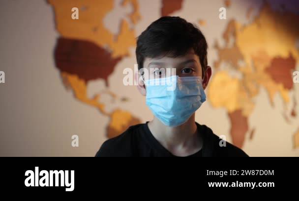 Young boy wearing protective face mask standing. Human population virus ...