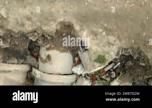 Concrete waste pipes. Streams of water flow through concrete pipes ...