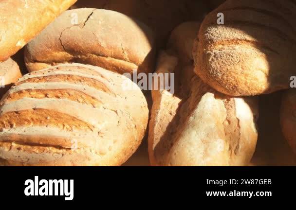 Bakehouse. Rows of fresh crusty bread loafs lying on the shelf.Baking ...