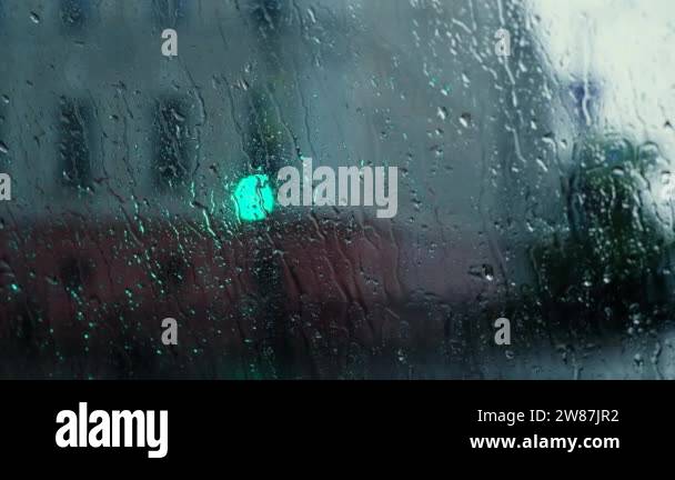 Rain Drops Falling on window with bokeh light effects. Heavy rain ...