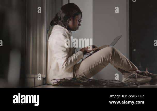 Full side view of intelligent African American female programmer ...