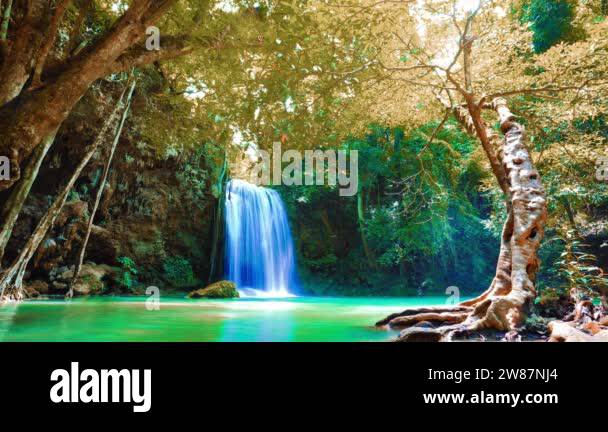 Waterfalls and fish swim in the emerald blue water in Erawan National ...