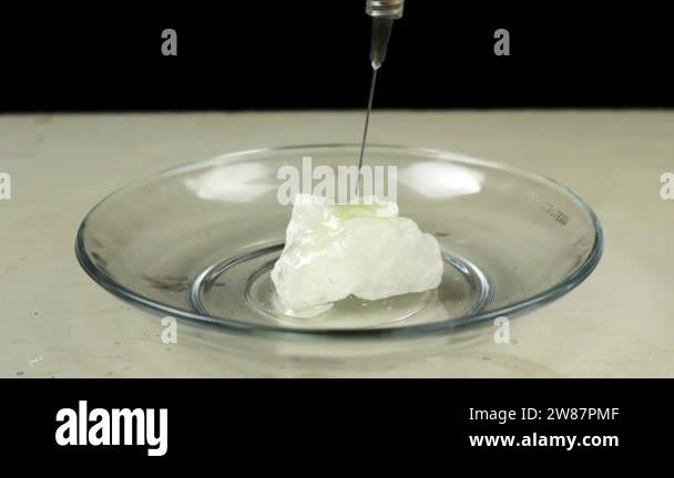 Pour sulfuric acid on sugar crystals on a glass plate. Dehydration ...