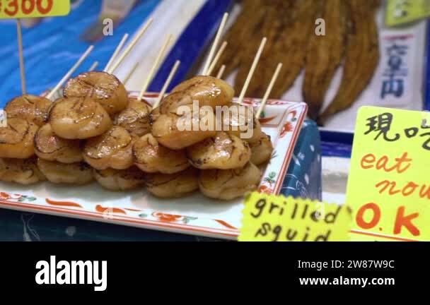 Slow motion of eating hotate sashimi. Merchants sale deliceous scallop ...
