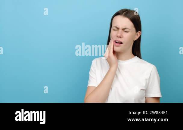 Unhappy sad young caucasian woman suffering from acute tooth pain ...