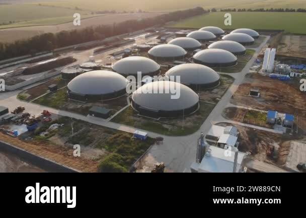 Biogas farm on green fields. Renewable energy from biomass. Modern ...