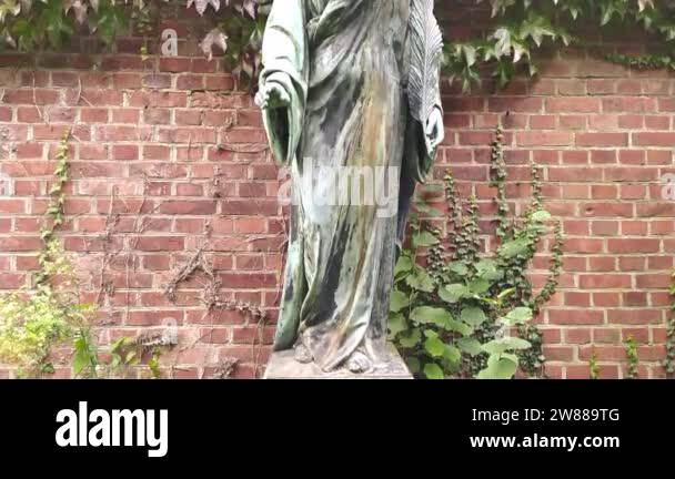 Bronze statue of an spiritual angel figure on a graveyard as cultural ...