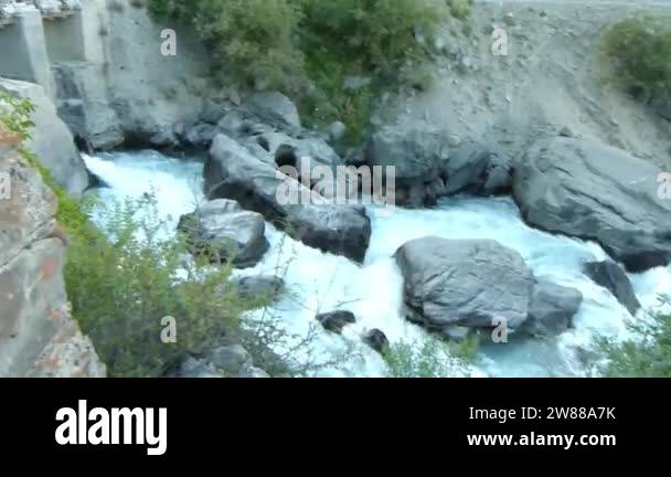 Water Source Flowing Near Flora in River Dam - Pan - Right To Left ...