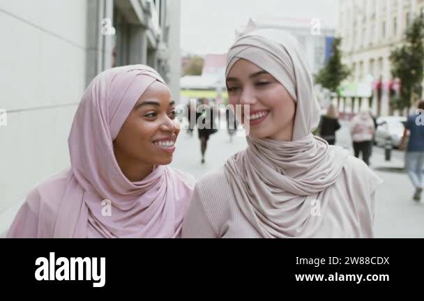 Female friendship. Two diverse muslim women friends enjoying shopping ...