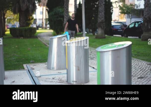 People dispose of metal, plastic, glass and paper wastes with garbage ...