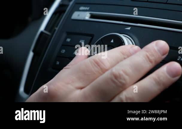 Male hand adjusts the tuning of the car radio, hands close up Stock ...