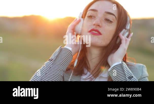 She found soundtrack of her mood. Portrait of positive good-looking ...